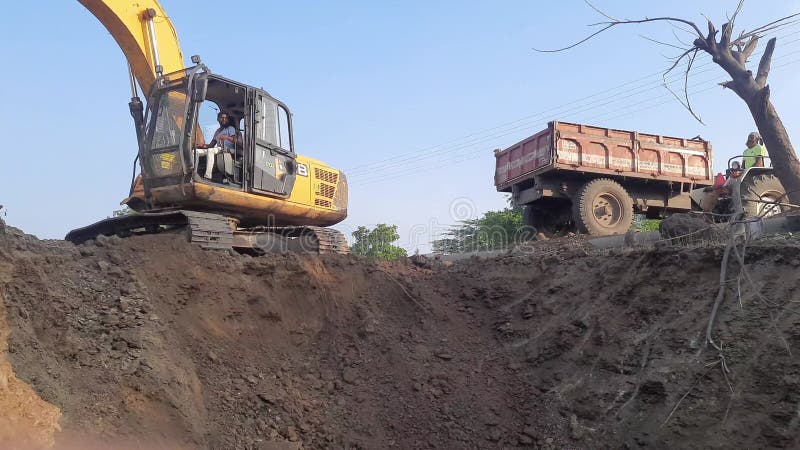 A Poclain Machine Excavator Machine Loads Moorum Soil into a Tractor at ...