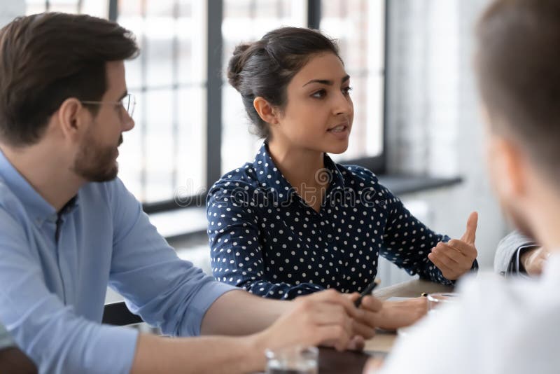 Young Indian Female Employee Talking To Colleagues at Workshop Stock ...
