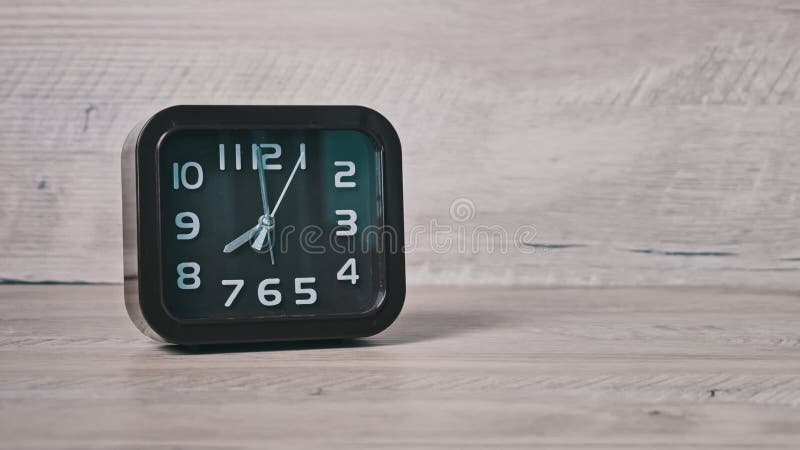 The Pointer Clock of Square Shape on Wooden Table Shows Time 8 Hours ...