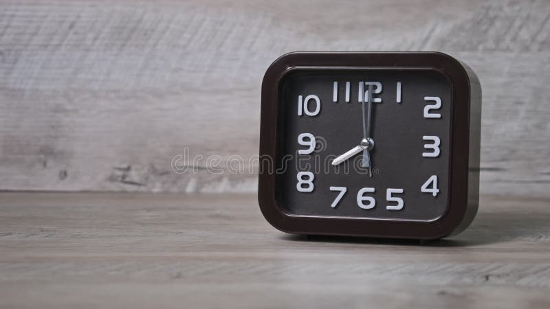 The Pointer Clock of Square Shape on Wooden Table Shows Time 8 Hours ...