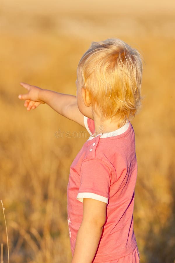 Pointing little girl stock photo. Image of person, standing - 240345026