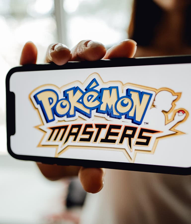 Hands Holding IPhone with Pokemon Masters on the Screen. Editorial ...