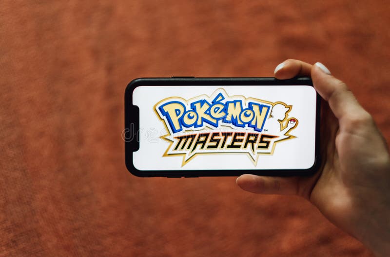 Hands Holding IPhone with Pokemon Masters on the Screen. Editorial ...
