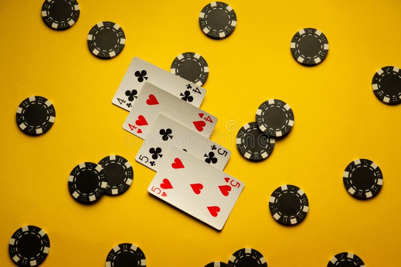 Poker Cards with a Combination of Two Pairs are on a Yellow Table with ...