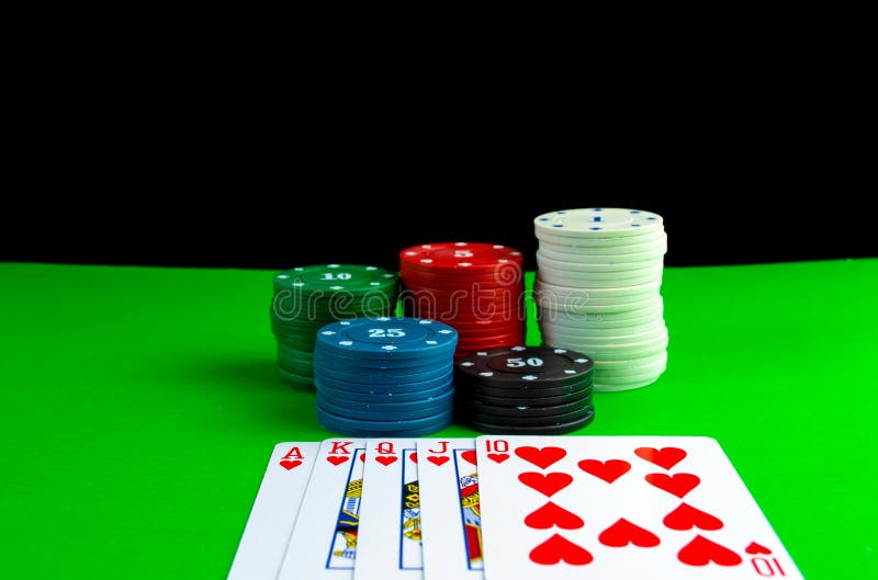 Poker Chips in Stacks and Royal Flush Cards on the Poker Table Stock ...