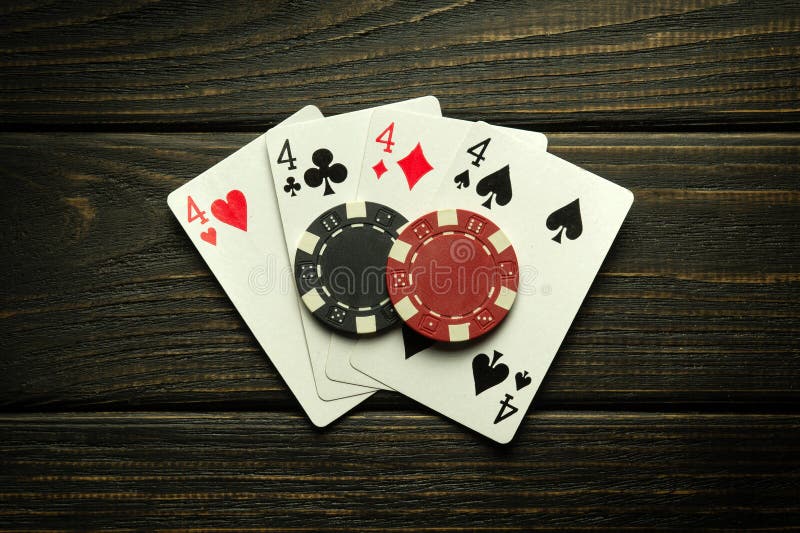 Poker Game with Four of Kind Combination. Chips and Cards on the Black ...