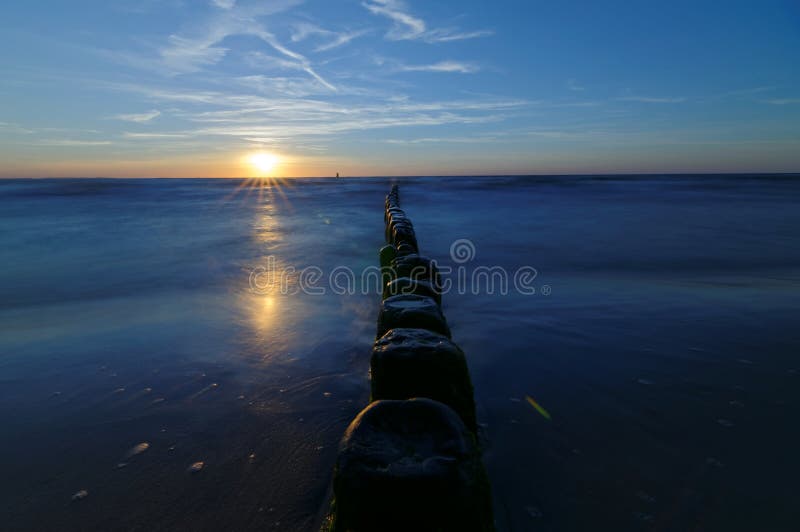 Poland, Baltic. Sunset Over the Sea. Breakwater on the Smooth Surface ...