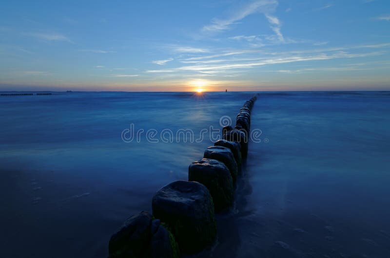 Poland, Baltic. Sunset Over the Sea. Breakwater on the Smooth Surface ...
