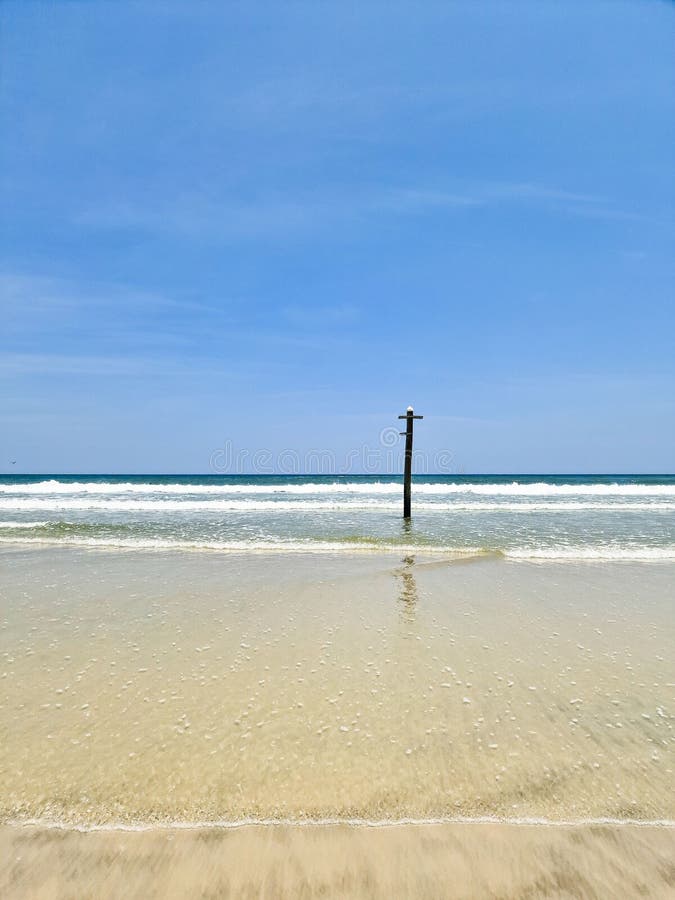 Pole on the Beach Splitting the Waves Stock Photo - Image of water ...