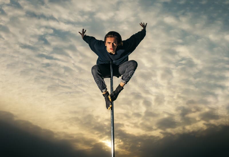 Pole Dance Fit Man Exercising with Pylon Outdoors in Sunset. Stock ...