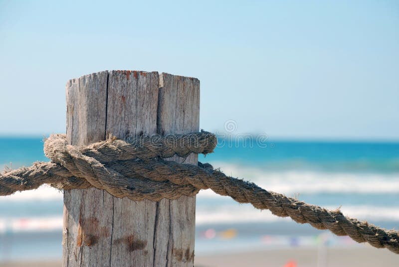 Pole with rope at beach stock image. Image of water, wooden - 18619221