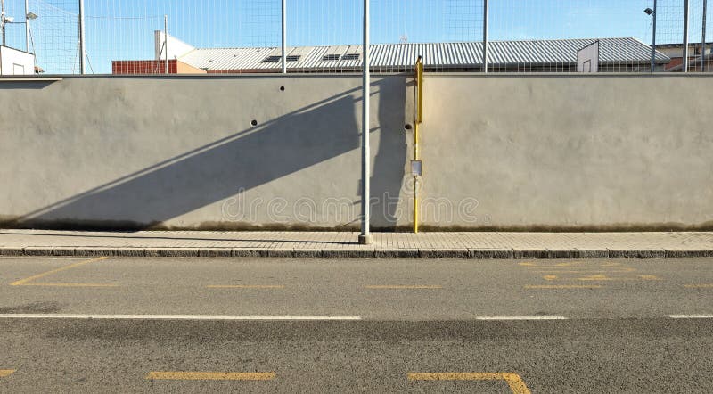 Pole on the Sidewalk with Bus Stop Sign and Concrete Wall Behind. Urban ...