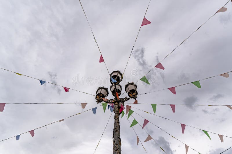 A Pole with Three Lights and Many Flags Hanging from it Stock Image ...