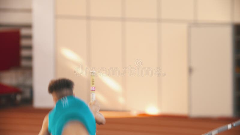 Pole Vault Training on the Stadium - a Young Man Jumping Over the Bar ...