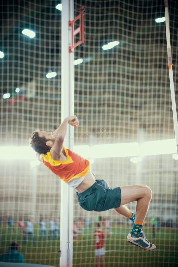 Pole Vaulting Indoors - An Athletic Man Falling Down After The Jump ...