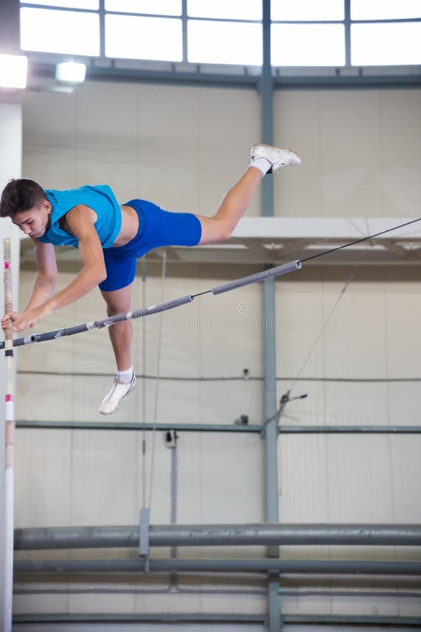 Pole Vaulting Indoors - Young Man Flying Over the Partition Stock Photo ...
