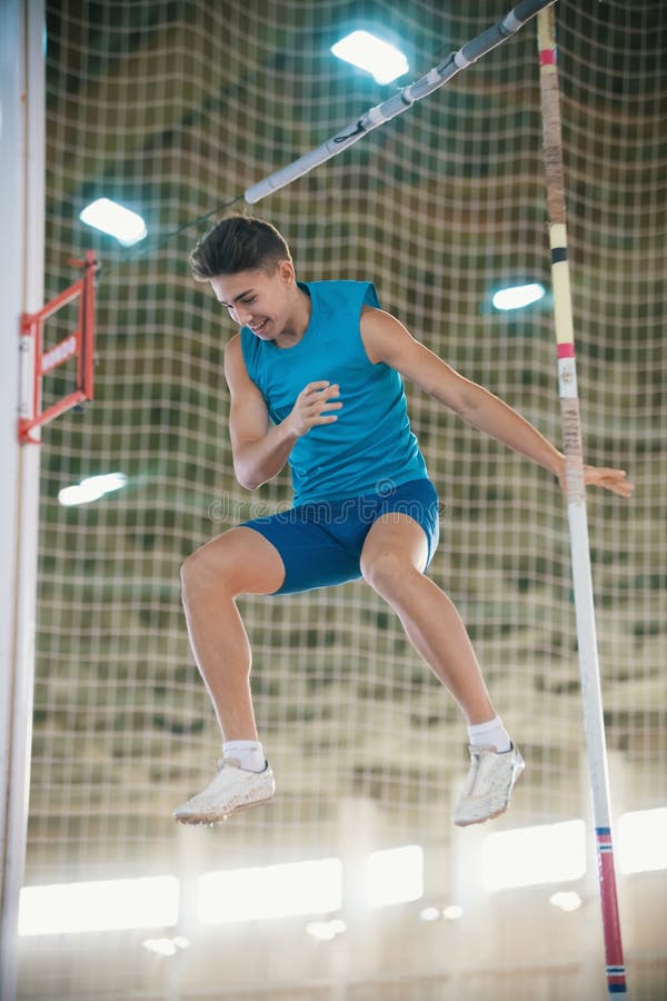 Pole Vaulting - Man is Falling after a Jump with a Pole and Smiling ...