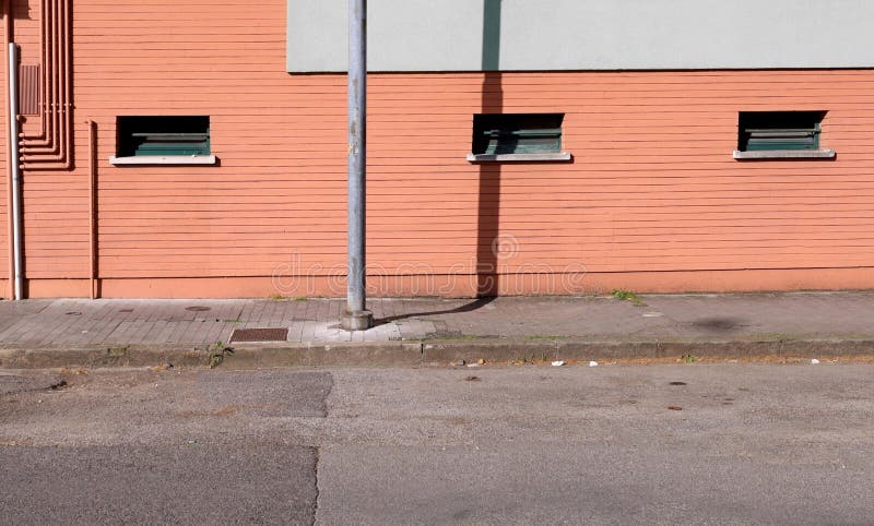 Pole on a Worn Sidewalk with Painted Brick Wall Facade on Behind and ...