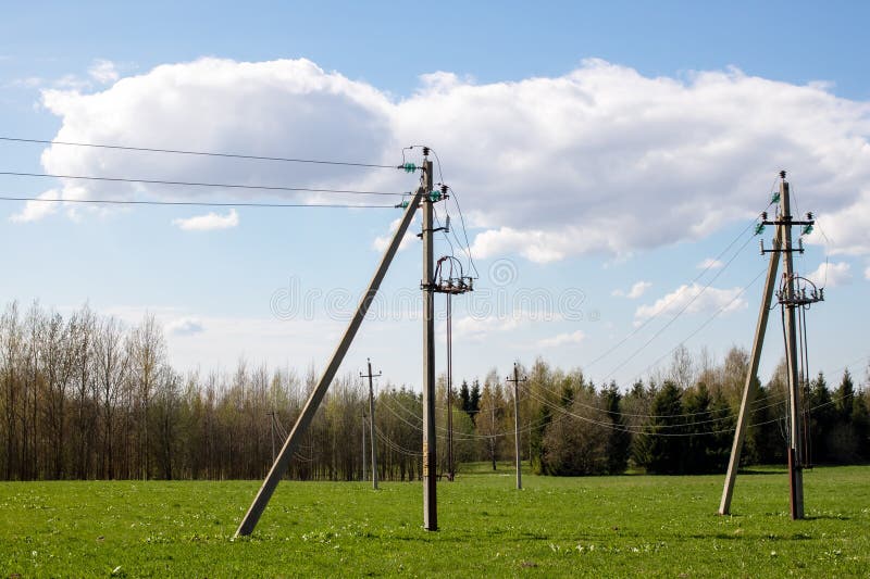 Poles with Electrical Wires in a Green Field Stock Photo - Image of ...
