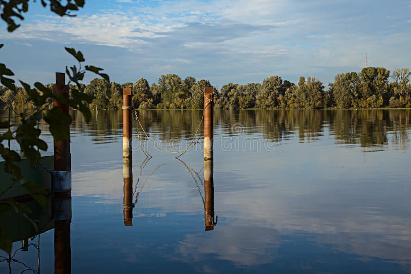 Poles of a Harbor at Sunset with Their Reflections Casted in the Water ...