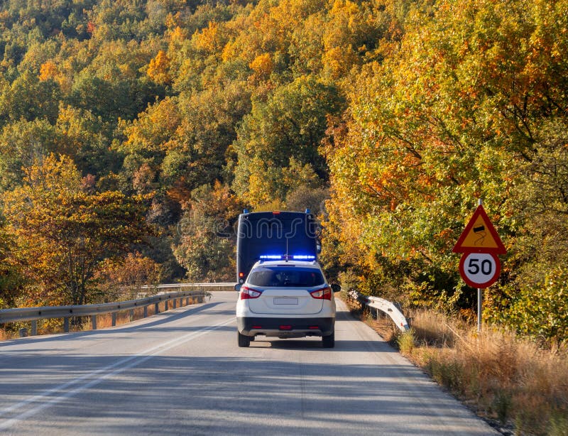 A Police Car Escorting a Bus on the Road in Greece in Autumn Stock ...