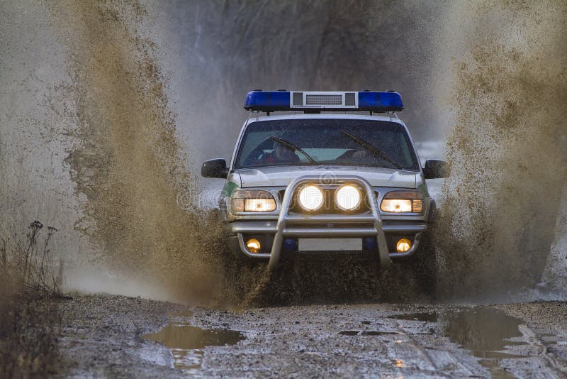 Police Car in the Field Driving through the Water Stock Photo - Image ...