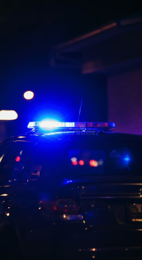 Police Car at Night with Flashing Blue Lights in Urban Setting Stock ...
