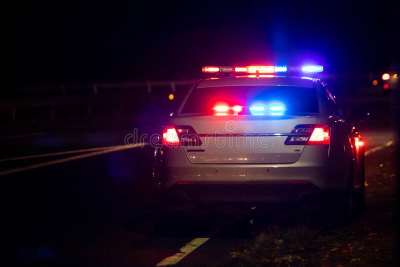 Police Car with Emergency Lights on Road with Caution Tape Stock Photo ...