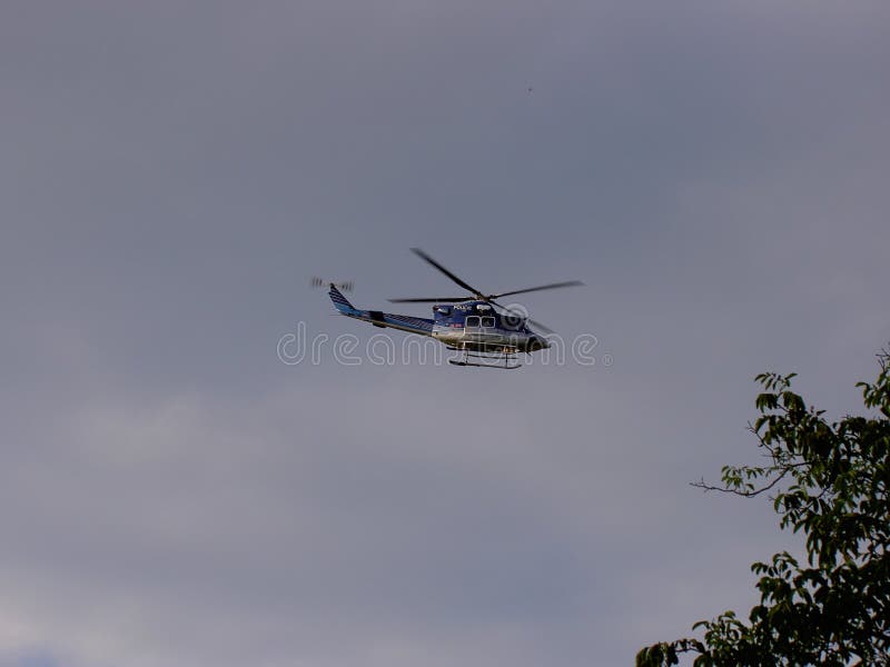 Police Helicopter Flying in the Blue Sky by Day, Side View Stock Image ...