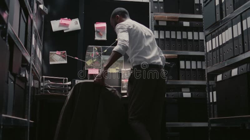 Police Inspector Analyzing Forensic Evidence on Map Stock Footage ...