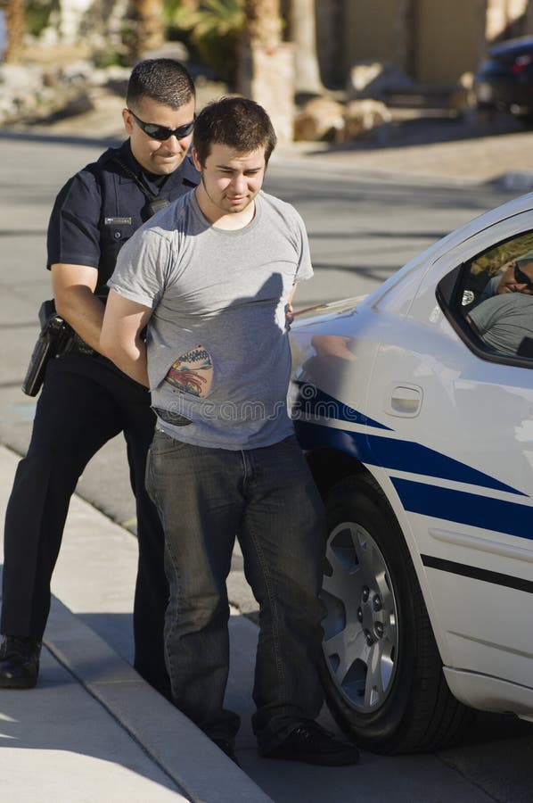 Police Officer Arresting Young Man Stock Photo - Image of occupation ...