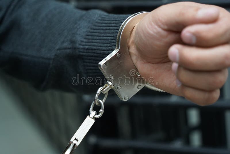 A Police Officer Handcuffs a Suspect Stock Photo - Image of hand ...