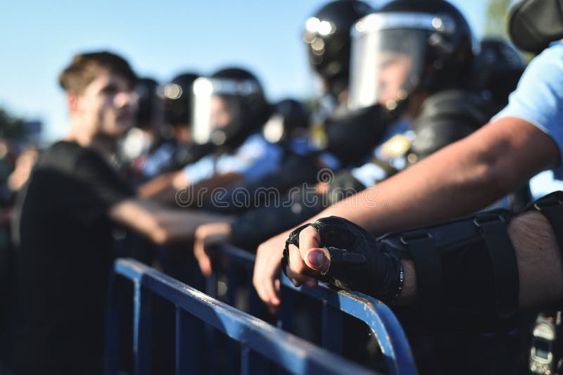 Security Staff Hands on a Protection Fence during a Riot Stock Photo ...