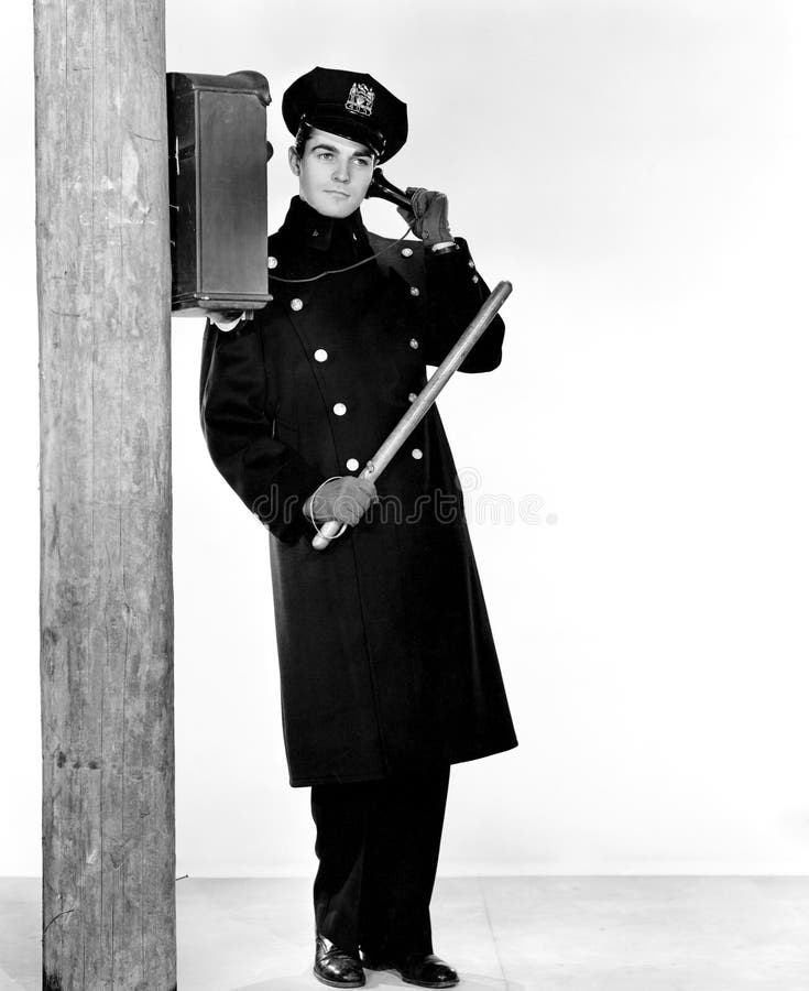 Police Officer Holding a Nightstick and Talking on a Phone Stock Image ...