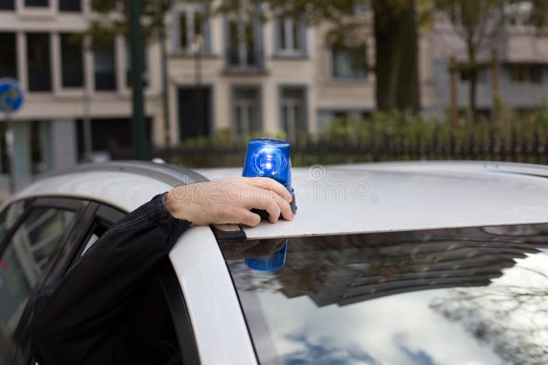 Police Officer Mounting Rotating Emergency Light on a Car Stock Image ...