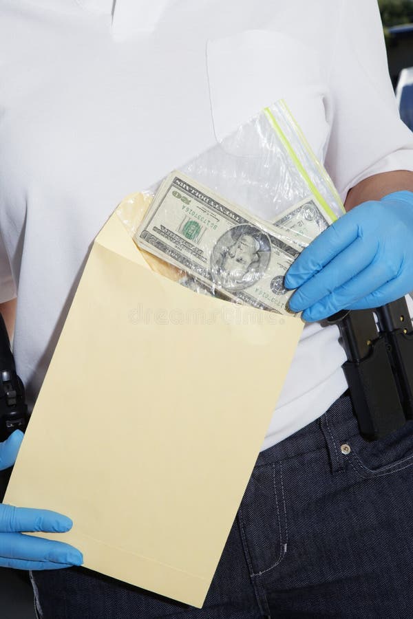 Police Officer Putting Money in Evidence Envelope Stock Image - Image ...