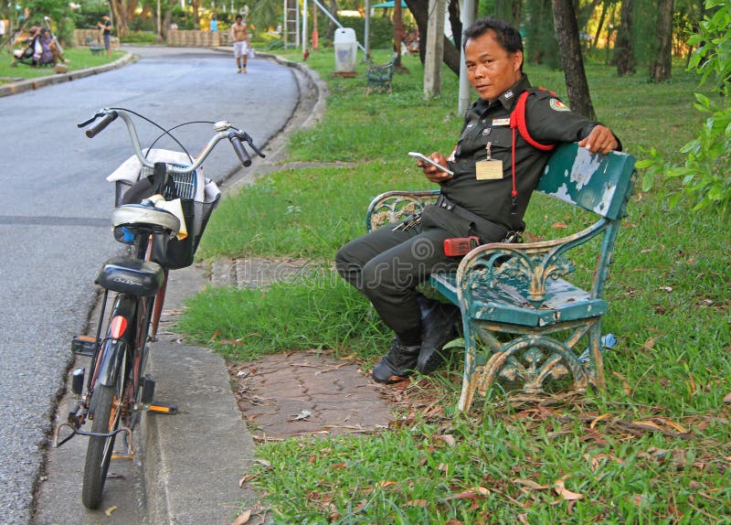 Police Officer is Resting on a Bench in Bangkok, Thailand Editorial ...