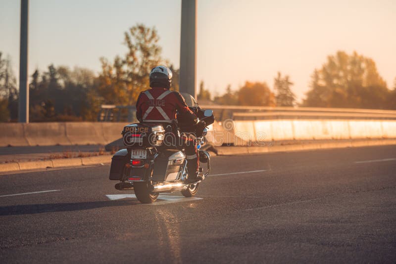 Police Officer Riding Away into the Sunset on a Motorcycle Stock Image ...