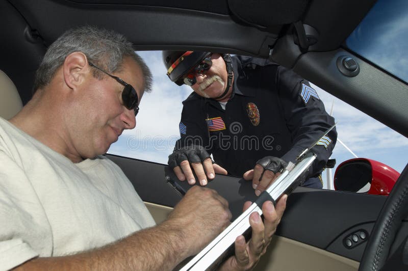 Police Officer Watching Driver Sign Papers Stock Photo - Image of ...