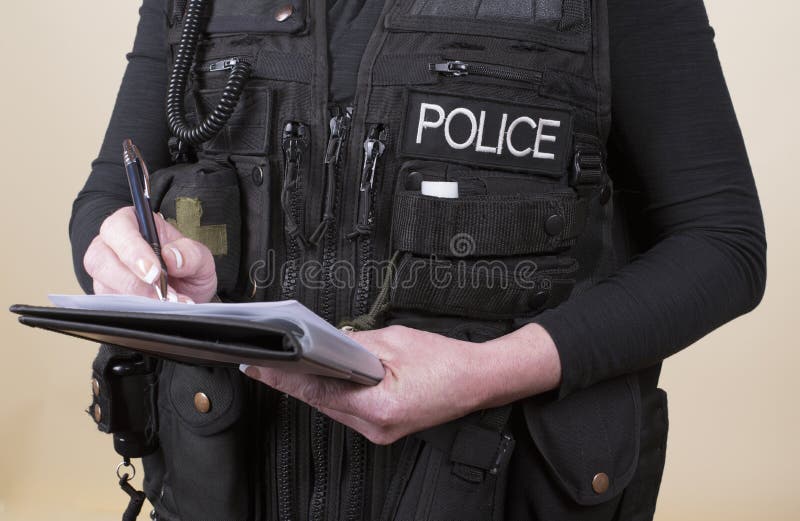 Police Officer Writing Notes Stock Photo - Image of wearing, tactical ...