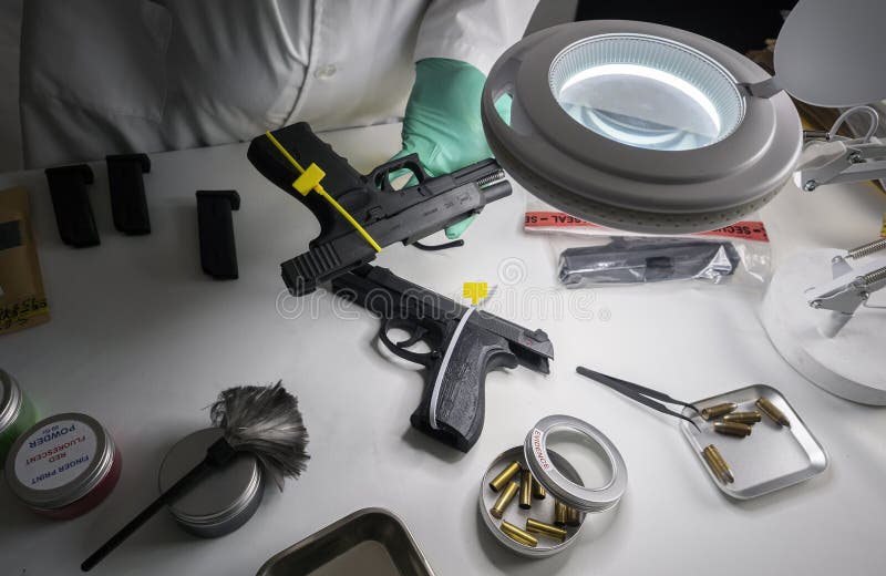 Police Scientist Pulls Firearm Evidence Out of Bag for Crime Lab ...