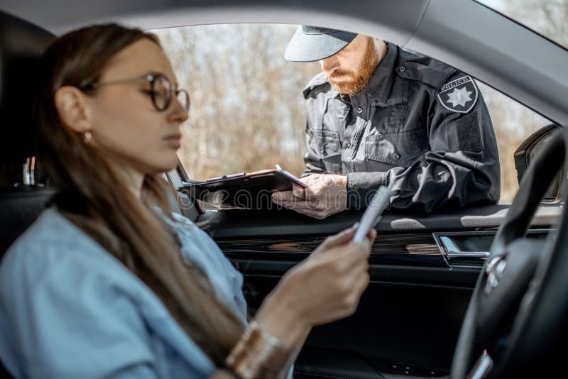Policeman Checking Documents of a Female Driver Stock Image - Image of ...
