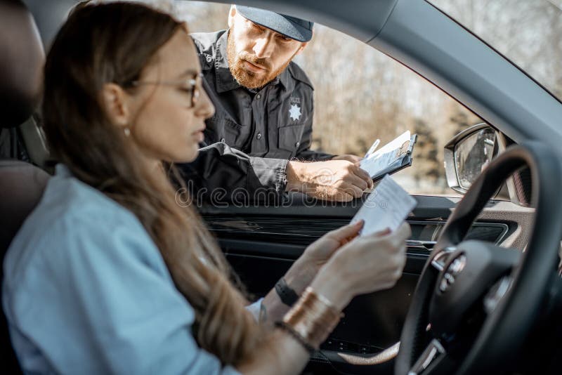 Policeman Checking Documents of a Female Driver Stock Image - Image of ...