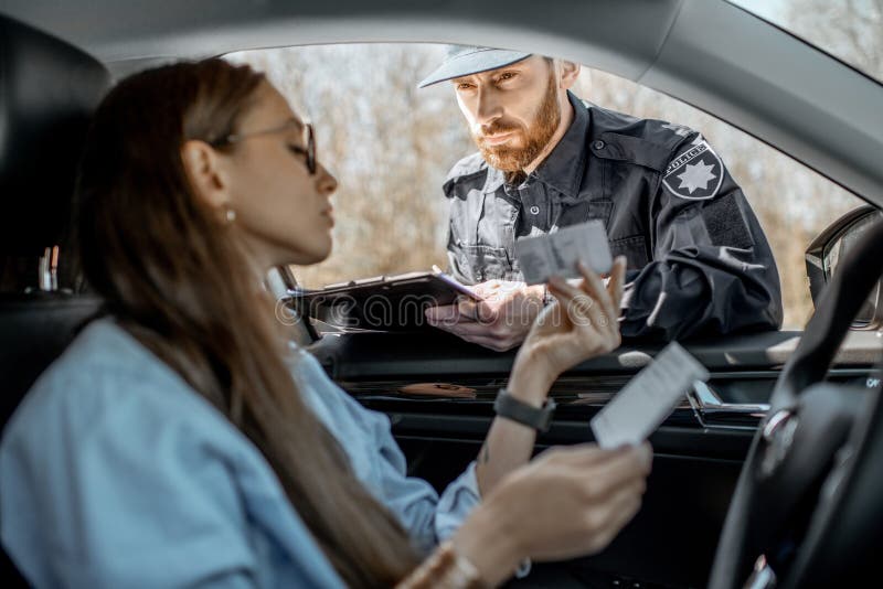 Policeman Checking Woman Driver for Alcohol Intoxication Stock Photo ...