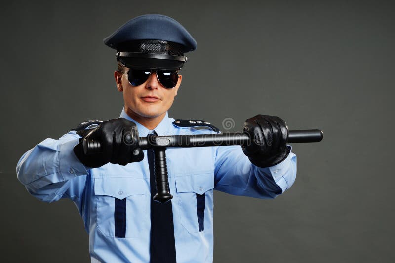 Policeman holds nightstick stock photo. Image of safety - 65151432