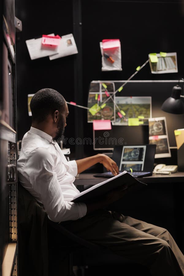 Policeman Stuying Crime Case and Analyzing Photos on Laptop Stock Image ...