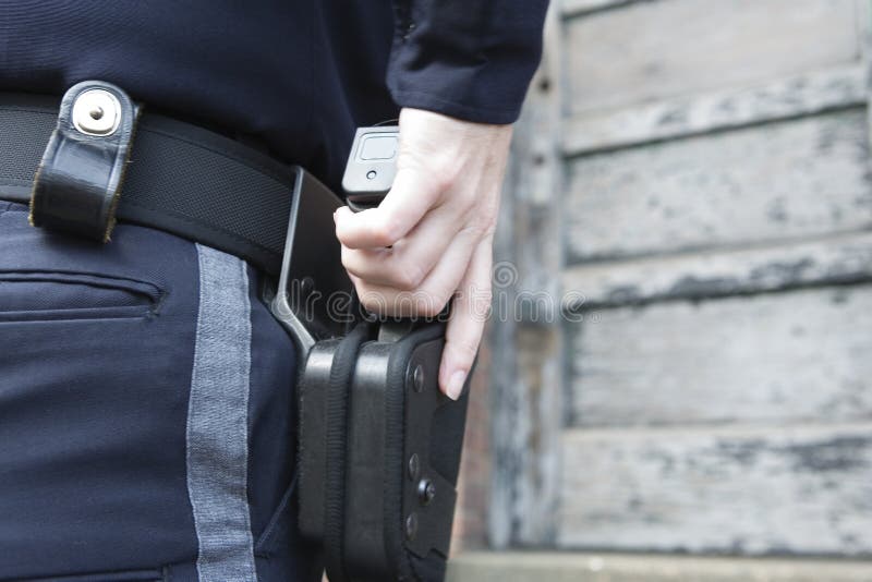 Policewoman on Patrol Checking Urban Building. Stock Photo - Image of ...