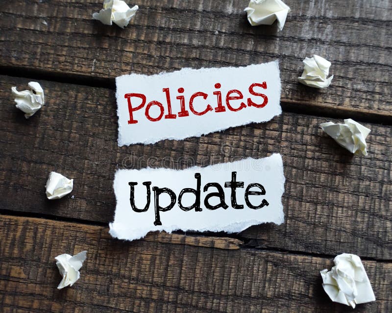 POLICIES UPDATE Words on a Small Sheet of Paper and a Wooden Table ...
