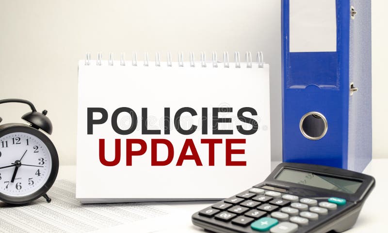 Policies Update Words on White Notebook with Clock, Calculator and ...