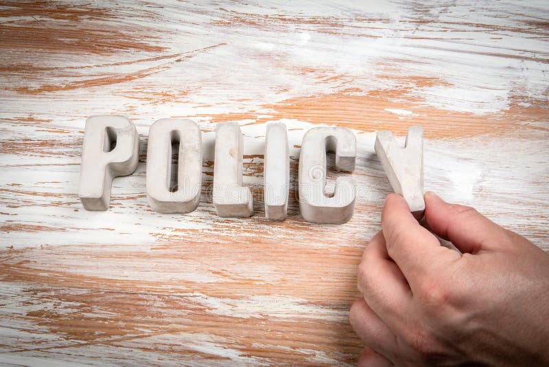 POLICY. Concrete Alphabet Letters on a Light Painted Wood Texture ...